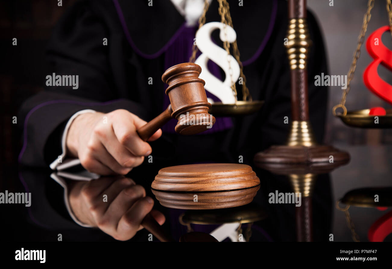 Judge, male judge in a courtroom striking the gavel Stock Photo - Alamy