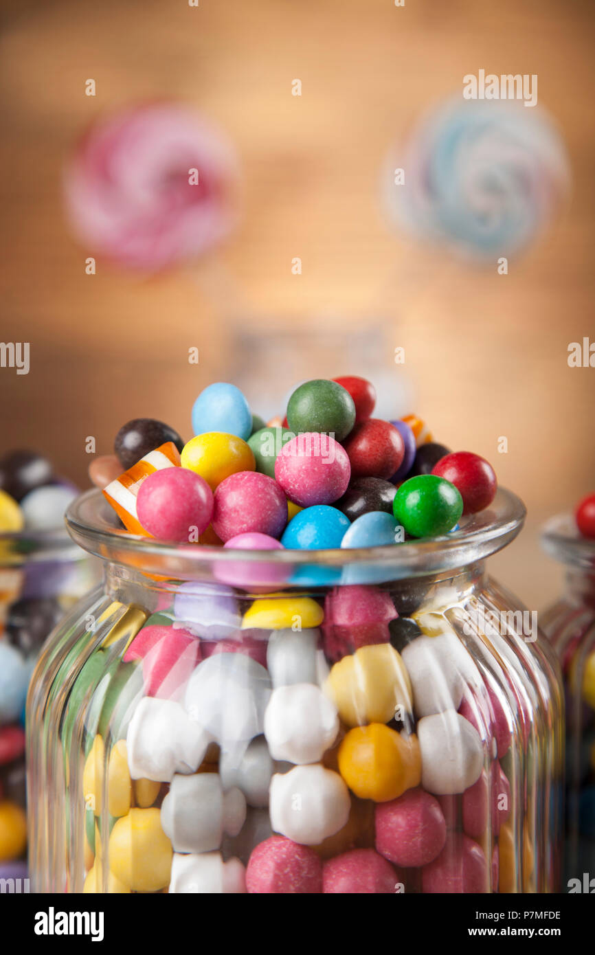 Colorful lollipops and different colored round candy and gum balls ...