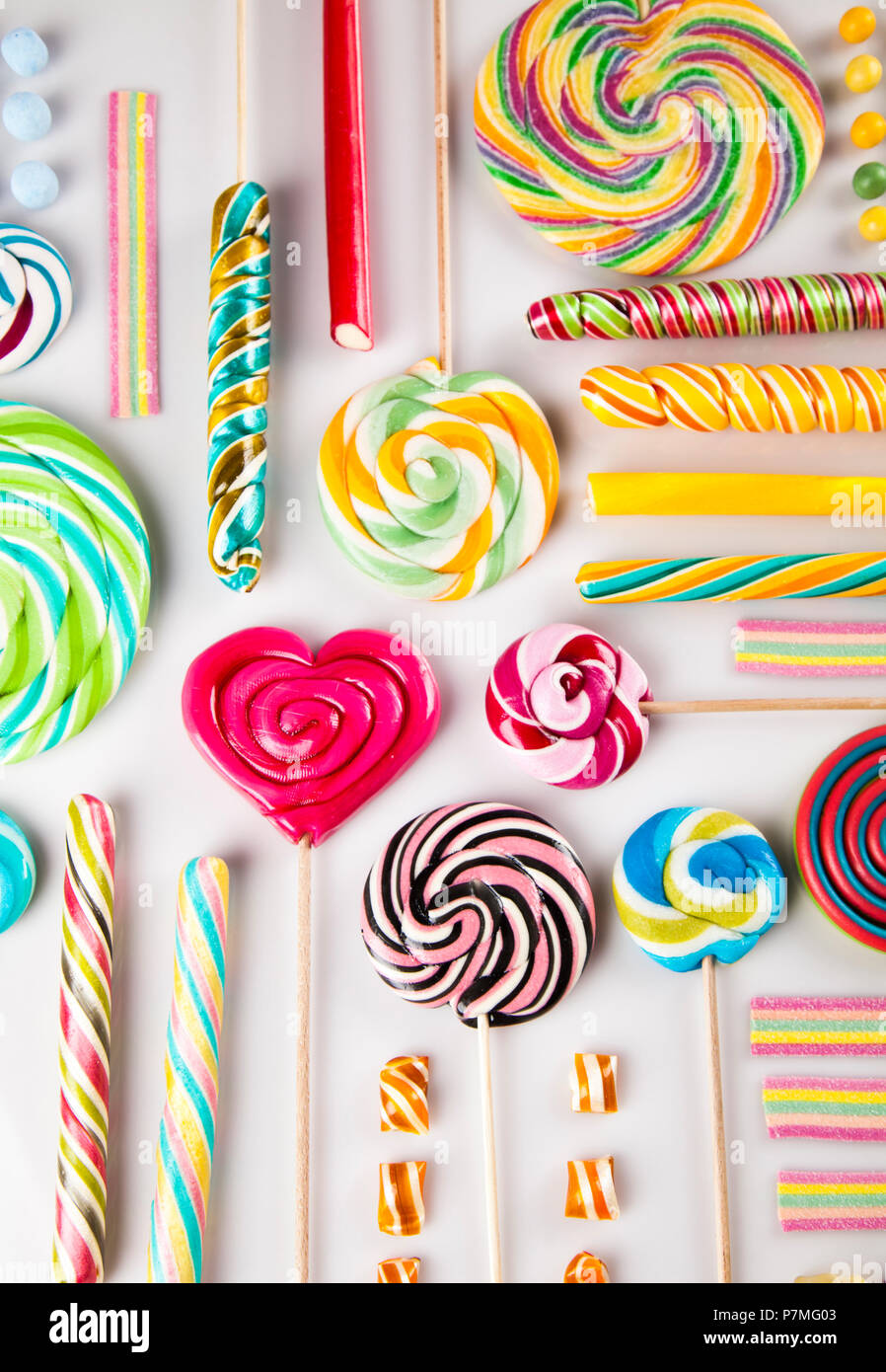 Colorful lollipops and different colored round candy and gum balls ...