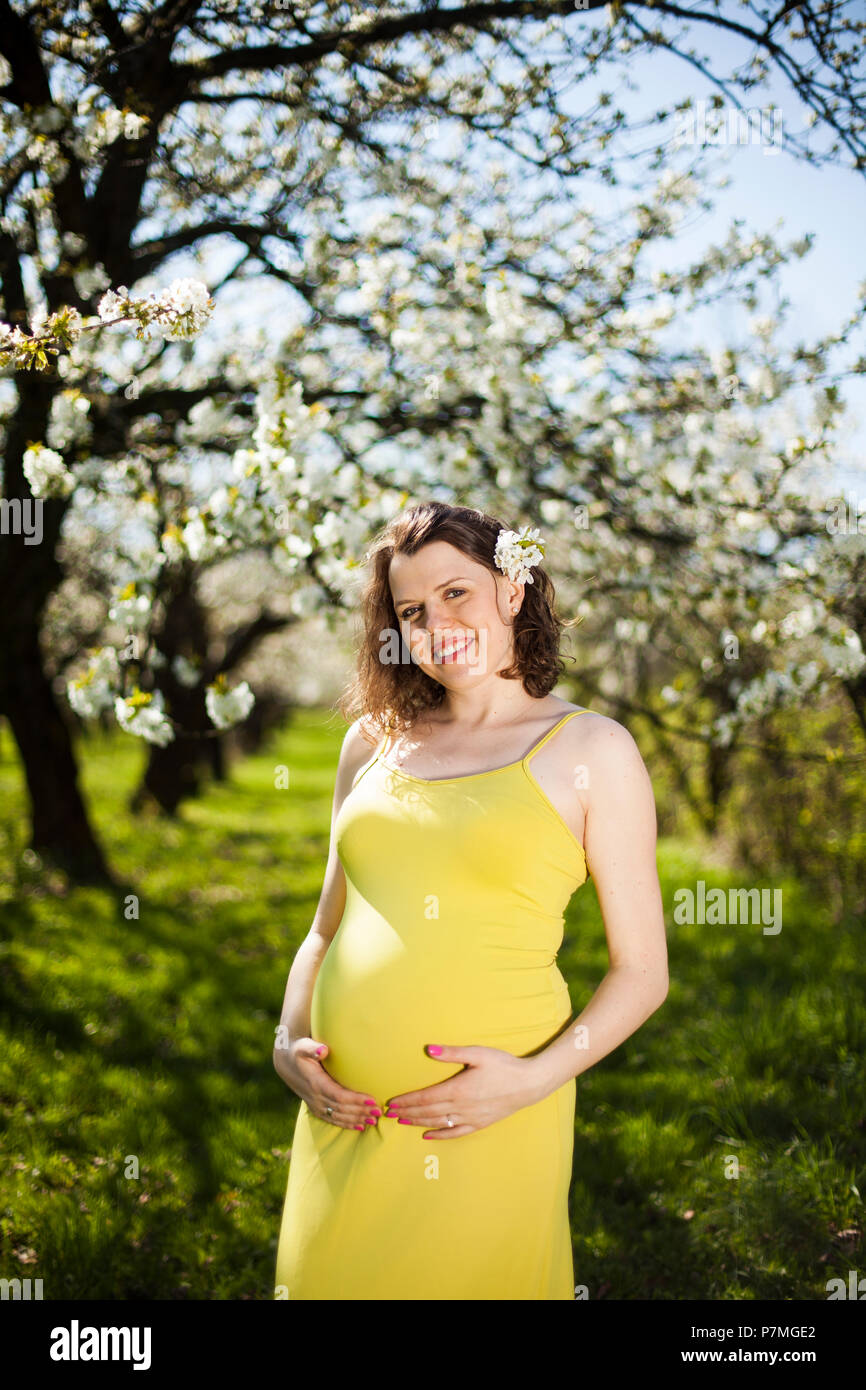 Beautiful pregnant woman relaxing outside in the Orchard Stock Photo ...