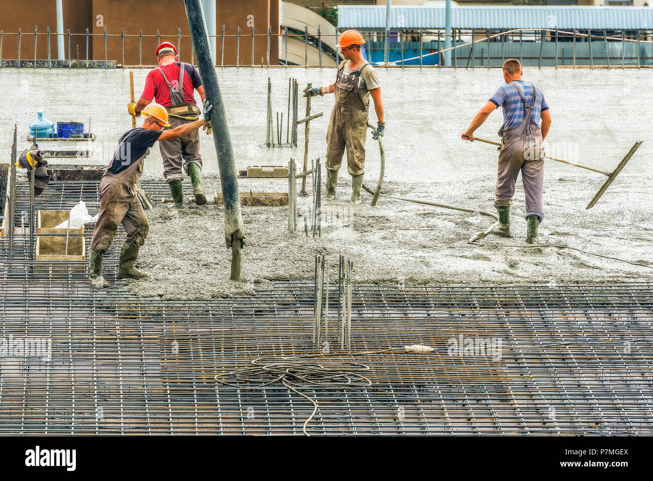 Workers work at the construction site. Concrete construction works are ...