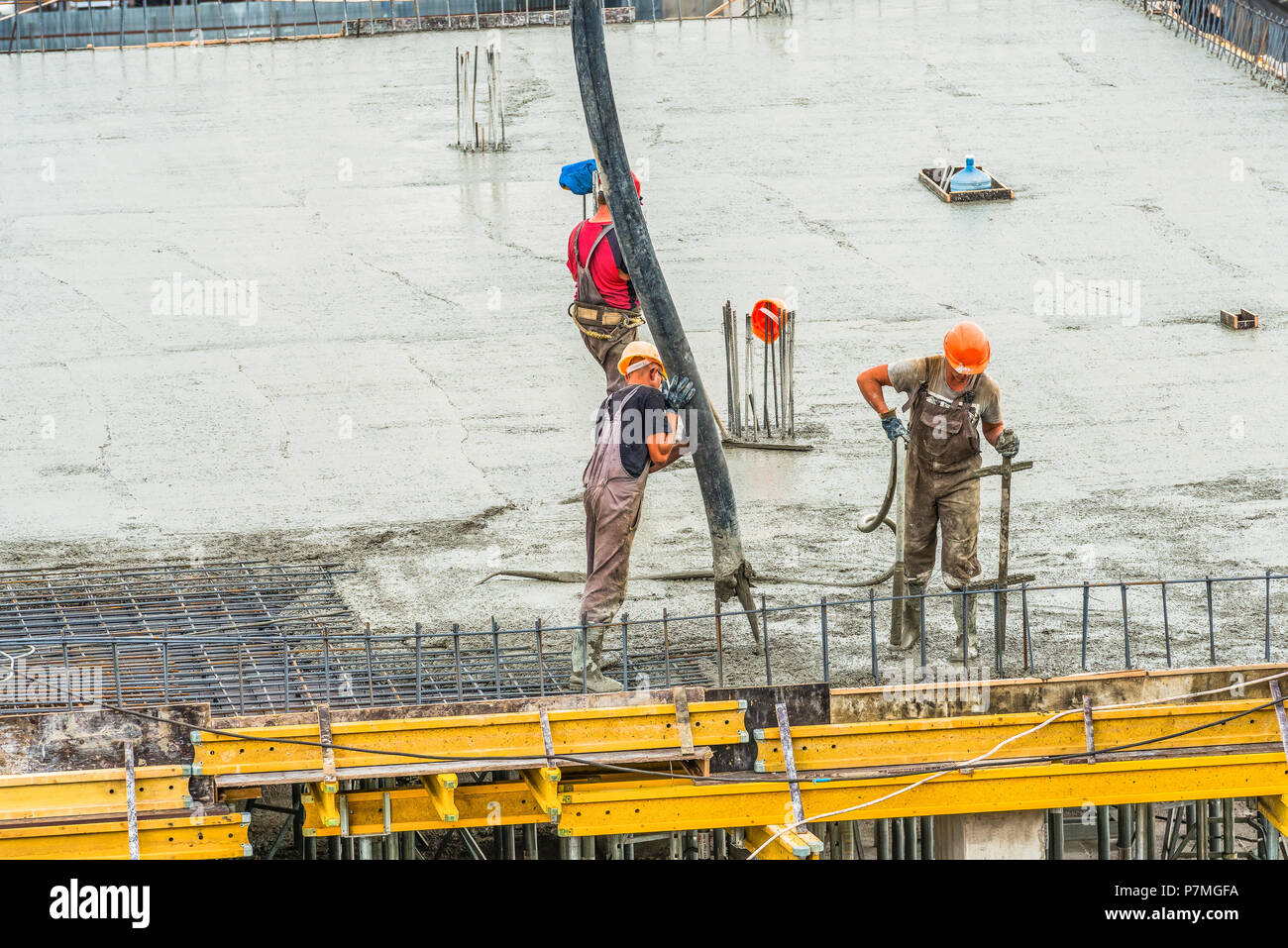 Workers work at the construction site. Concrete construction works are ...