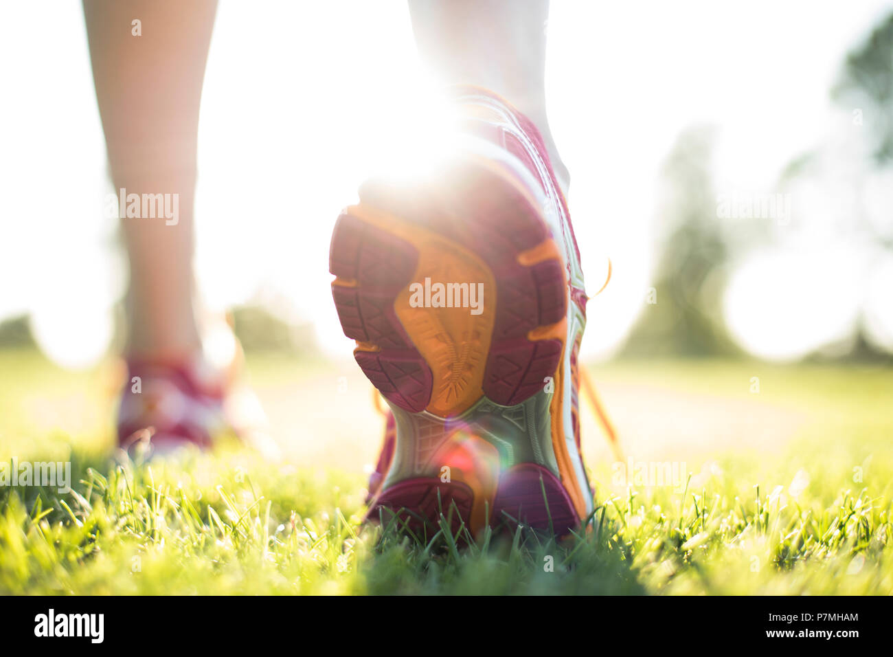 Runner feet running on road closeup on shoe Stock Photo - Alamy