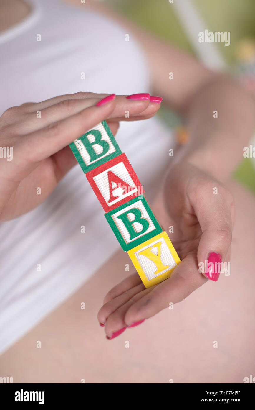 Wooden toy cubes with letters, Baby, Pregnancy concept Stock Photo - Alamy