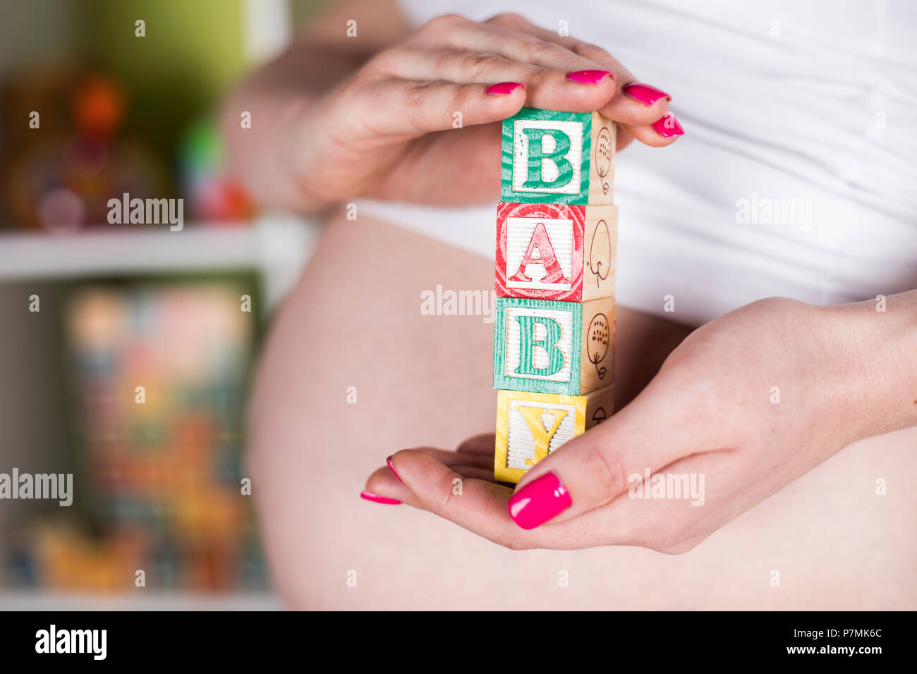 Wooden toy cubes with letters, Baby, Pregnancy concept Stock Photo - Alamy