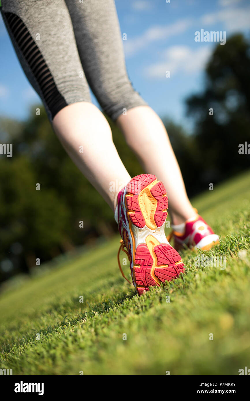 Runner feet running on road closeup on shoe Stock Photo - Alamy