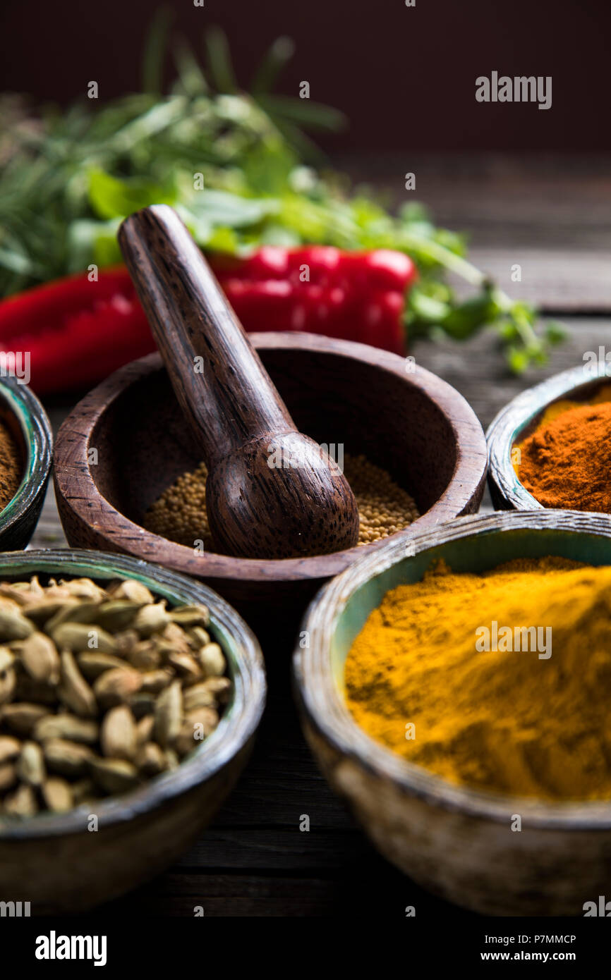Wooden table of colorful spices Stock Photo - Alamy