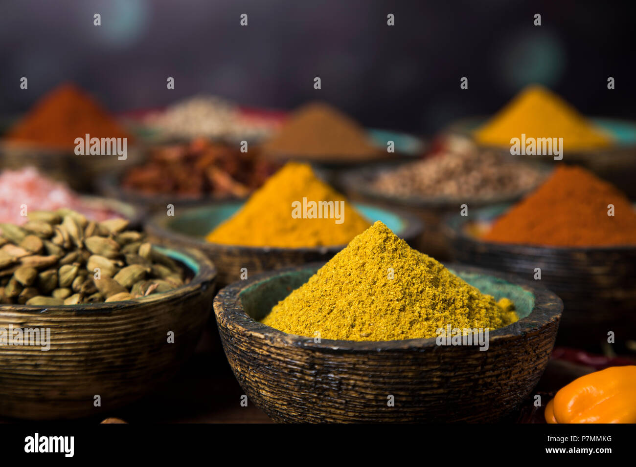 Wooden table of colorful spices Stock Photo - Alamy