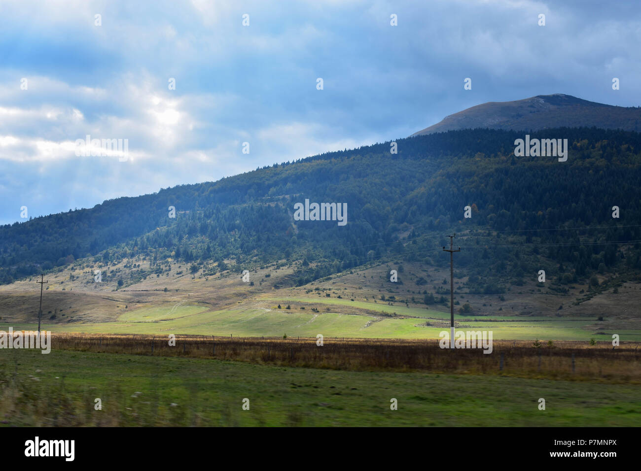 Beautiful countryside scene whit fields and mountain as background ...