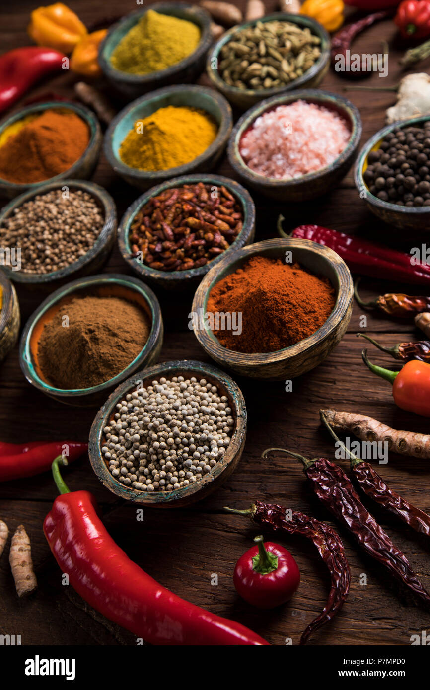 Wooden table of colorful spices Stock Photo - Alamy