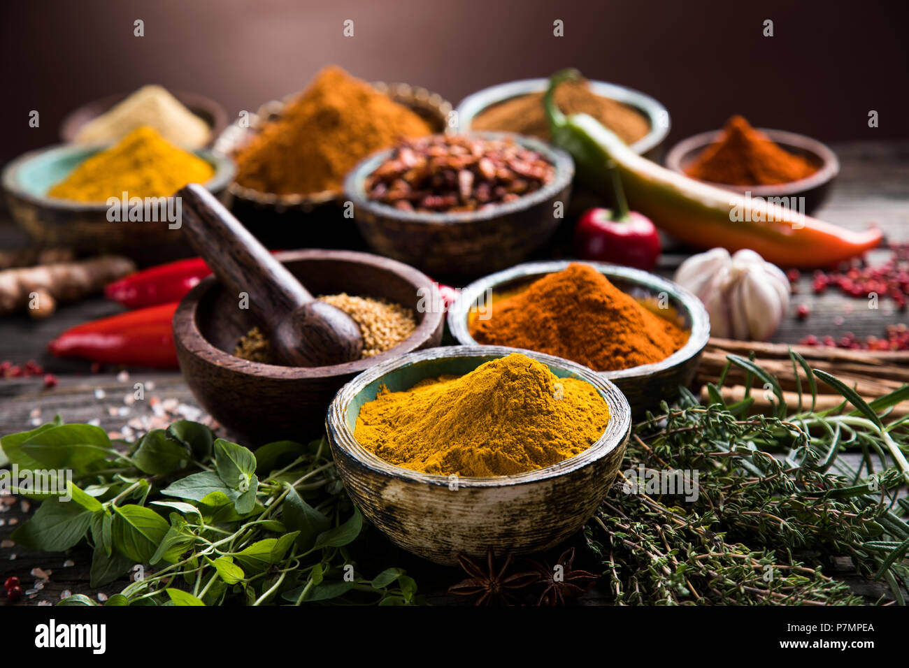 Wooden table of colorful spices Stock Photo - Alamy