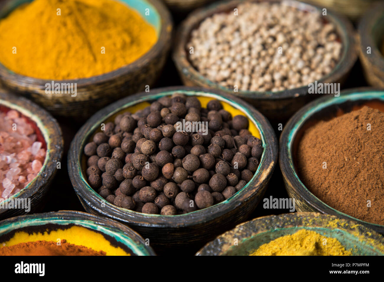 Wooden table of colorful spices Stock Photo - Alamy