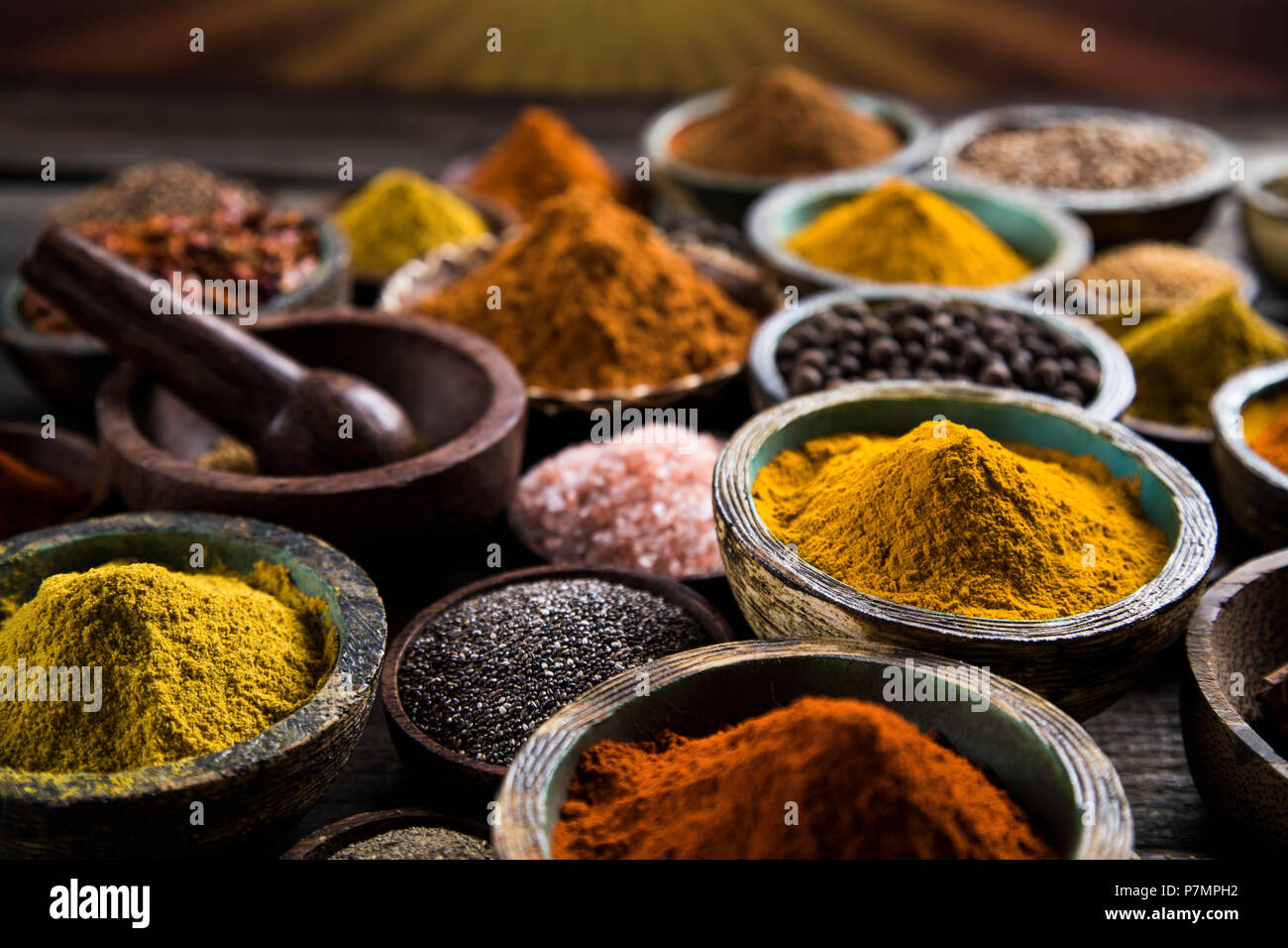 Wooden table of colorful spices Stock Photo - Alamy