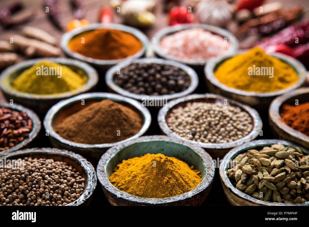 Wooden table of colorful spices Stock Photo - Alamy