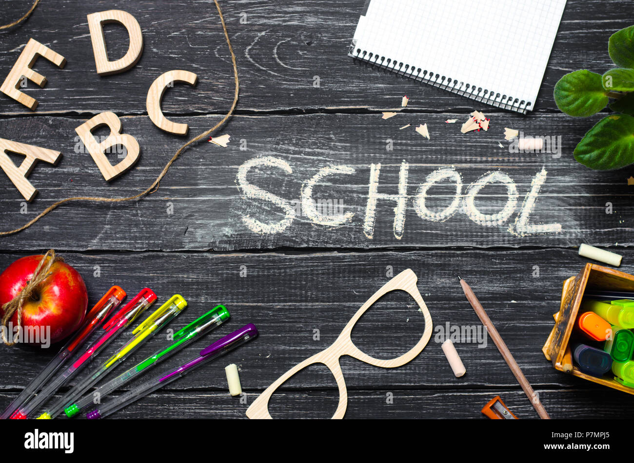 A student's desk on a school board, a dark wooden background made of ...