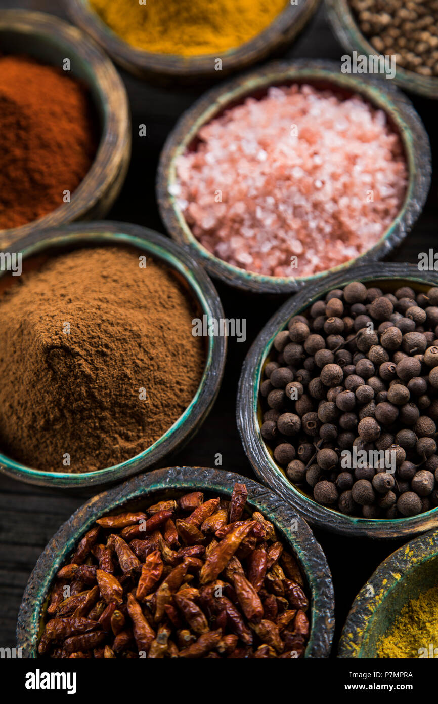Wooden table of colorful spices Stock Photo - Alamy