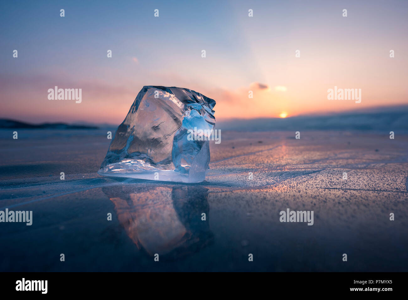 A cube of ice on the flat frosen lake at sunset, Baikal, Irkutsk region ...