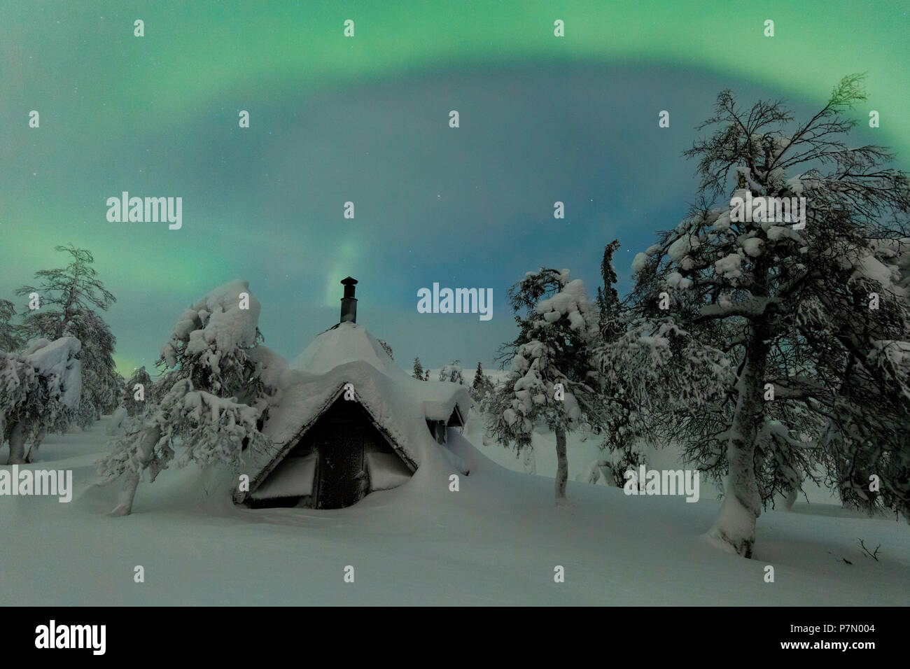 Northern lights on wood hut covered with snow, Pallas-Yllastunturi ...