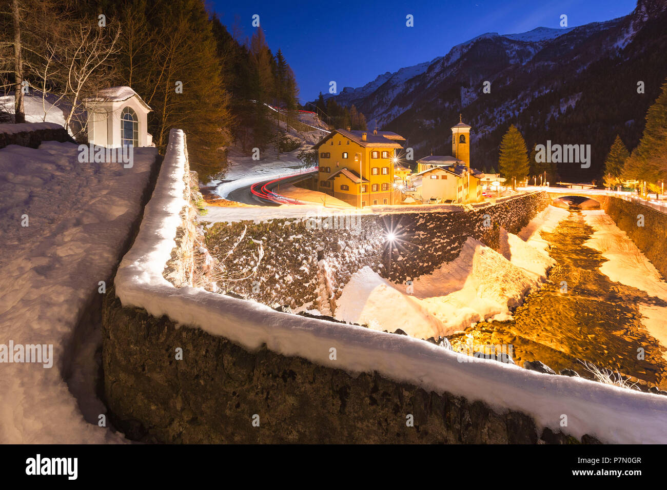 A snowy view of Campodolcino village from Ponte Romano at dusk, Spluga ...