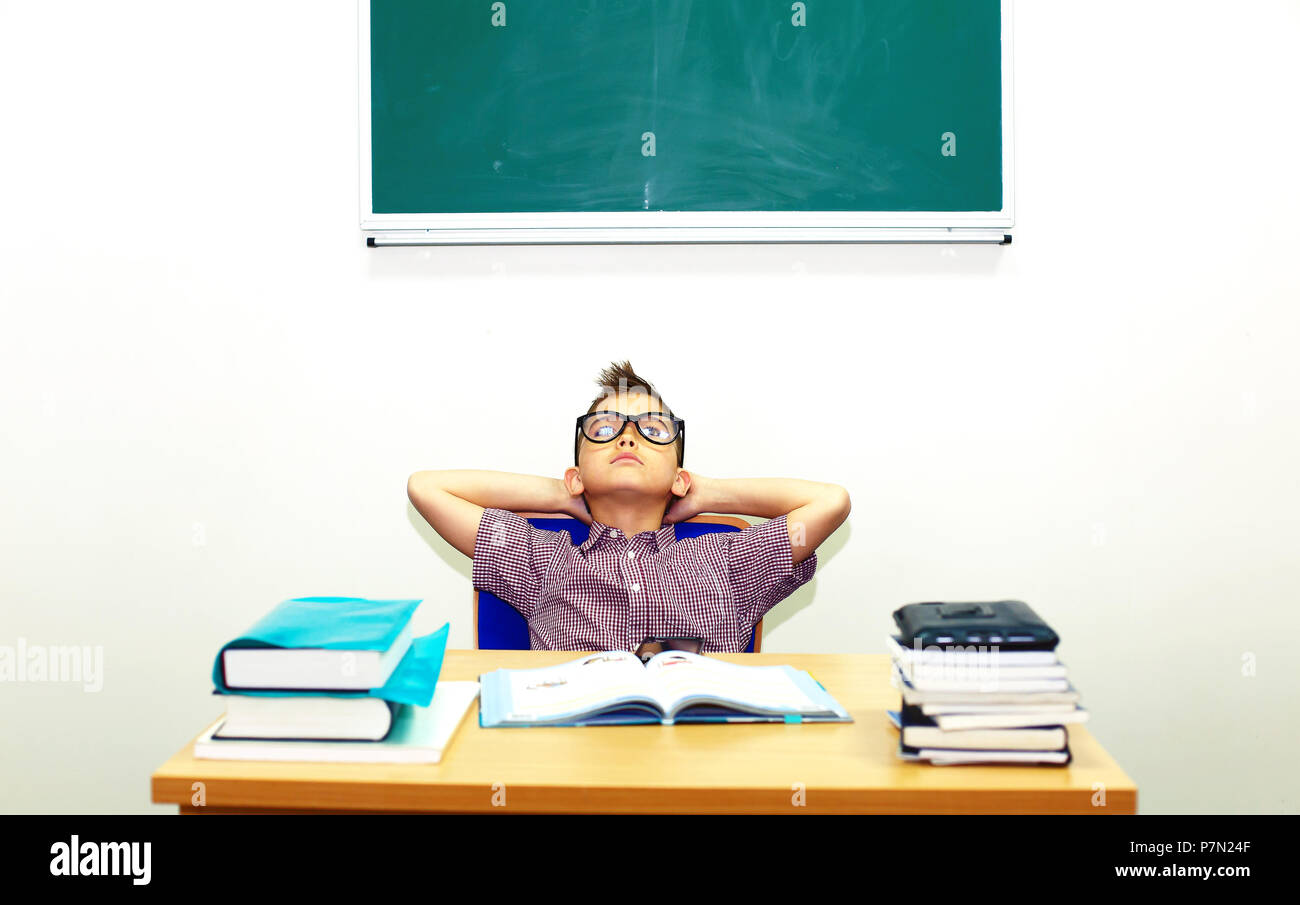 Smart schoolboy doing homework at school Stock Photo - Alamy