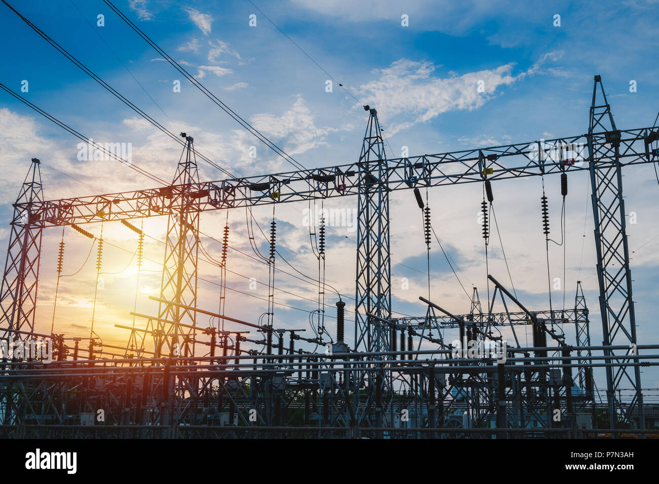 Sunset behind substation towers with blue sky Stock Photo - Alamy