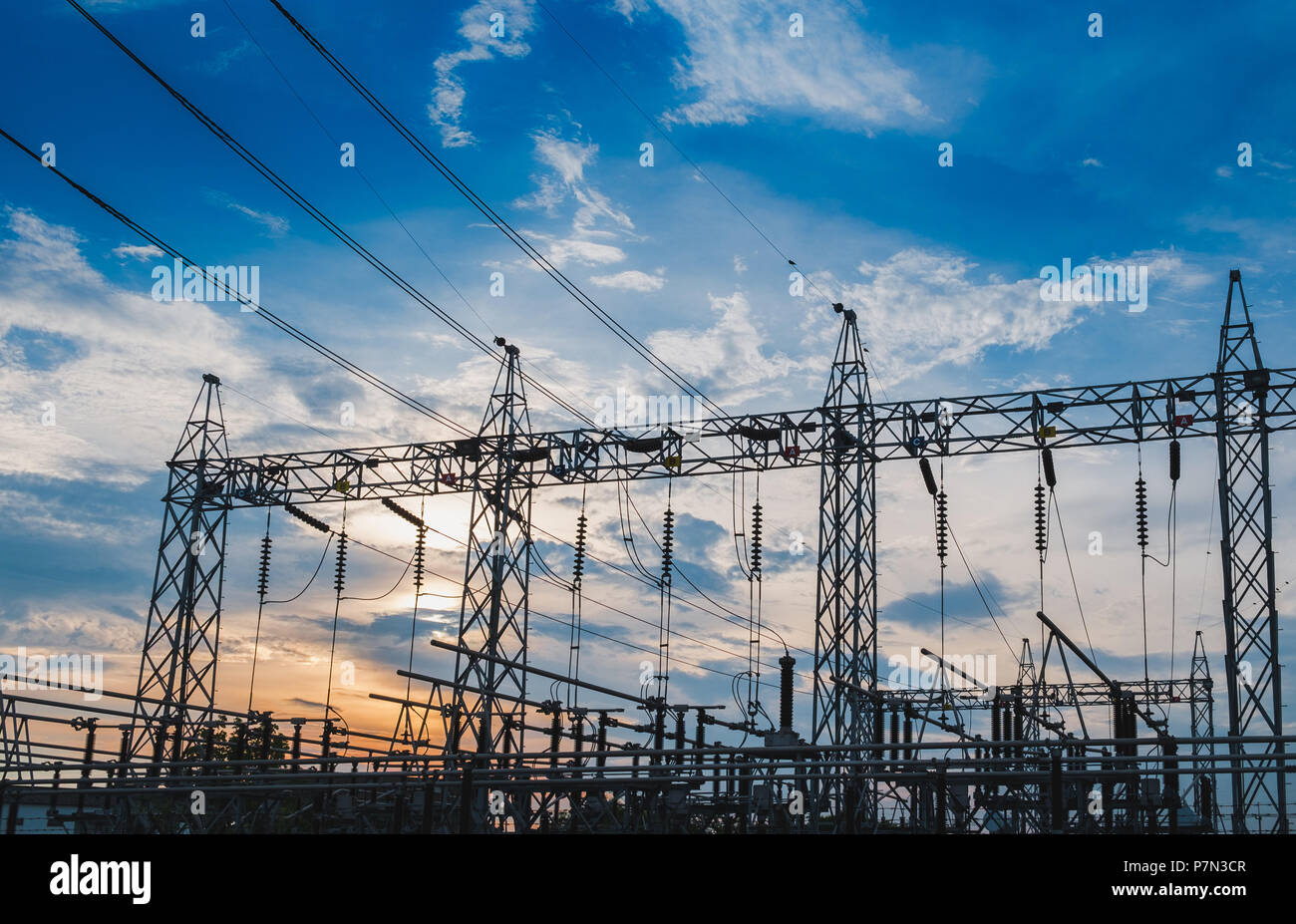 Sunset behind substation towers with blue sky Stock Photo - Alamy