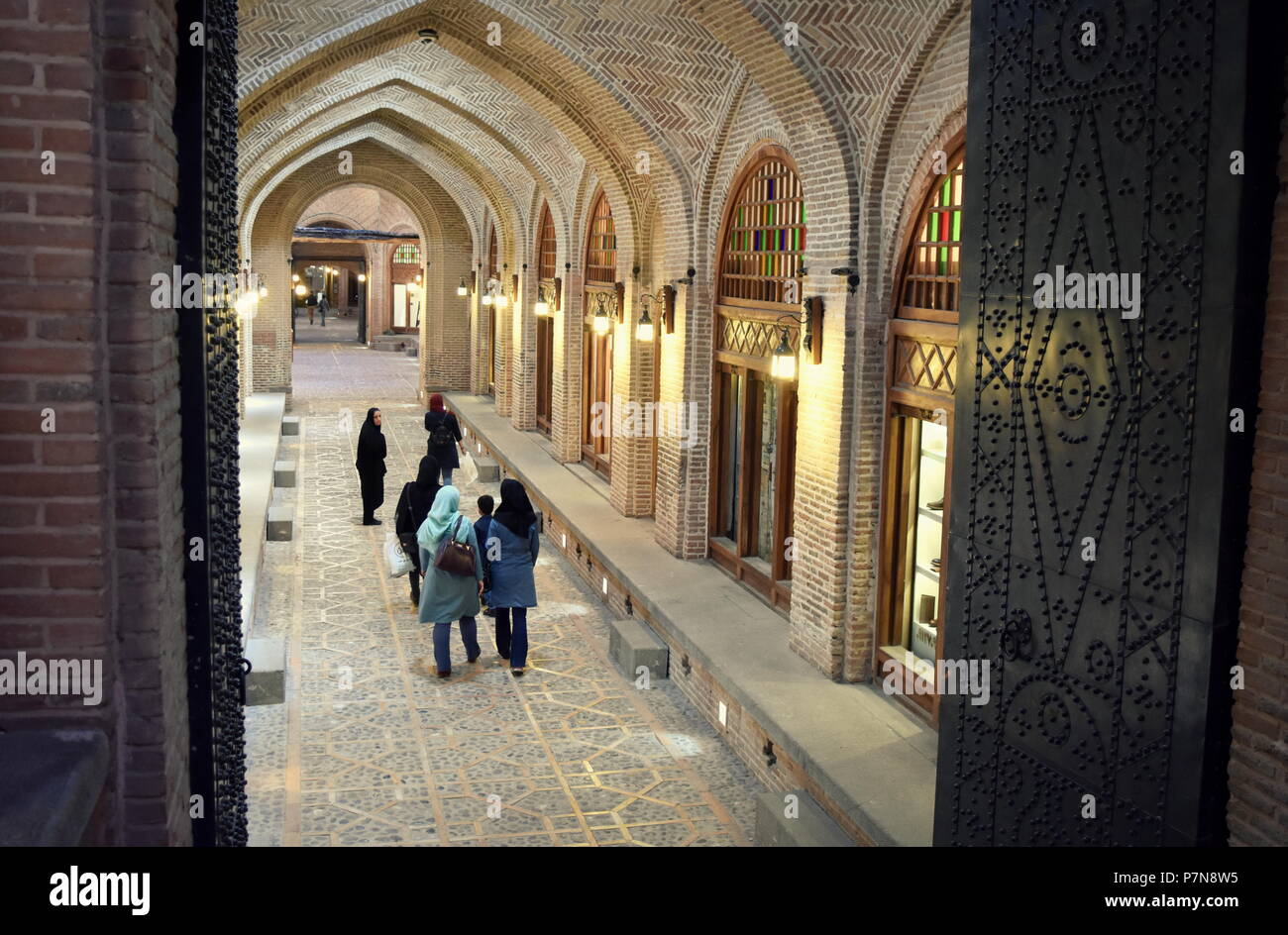 Muslim people walk along corridor of old Silk Road era Middle East ...