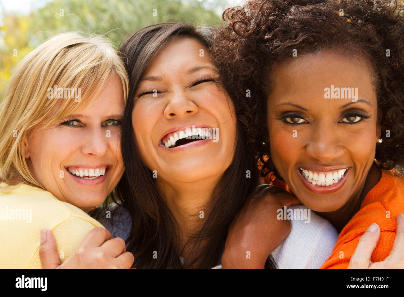 Diverse group of friends talking and laughing Stock Photo - Alamy