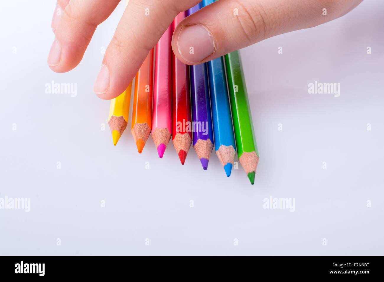 Hand holding color Pencils placed on a white background Stock Photo - Alamy