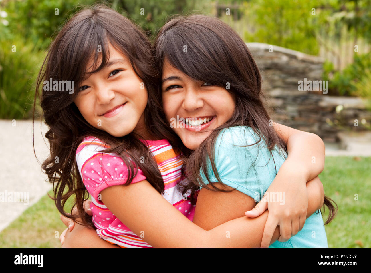 Sisters having fun laughing and playing together Stock Photo - Alamy