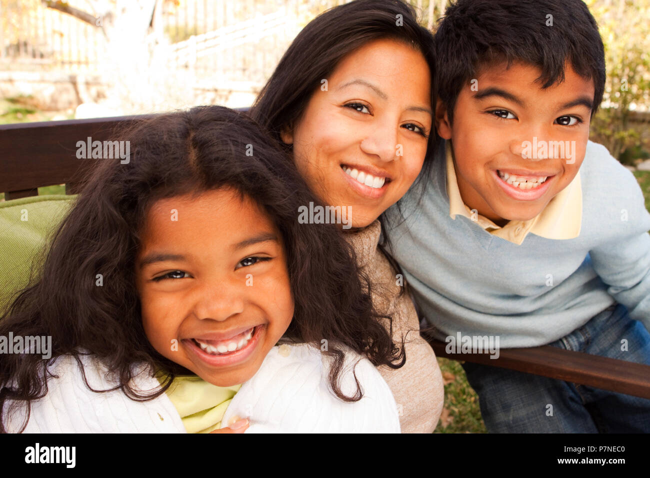 Biracial family laughing and smiling outside Stock Photo - Alamy