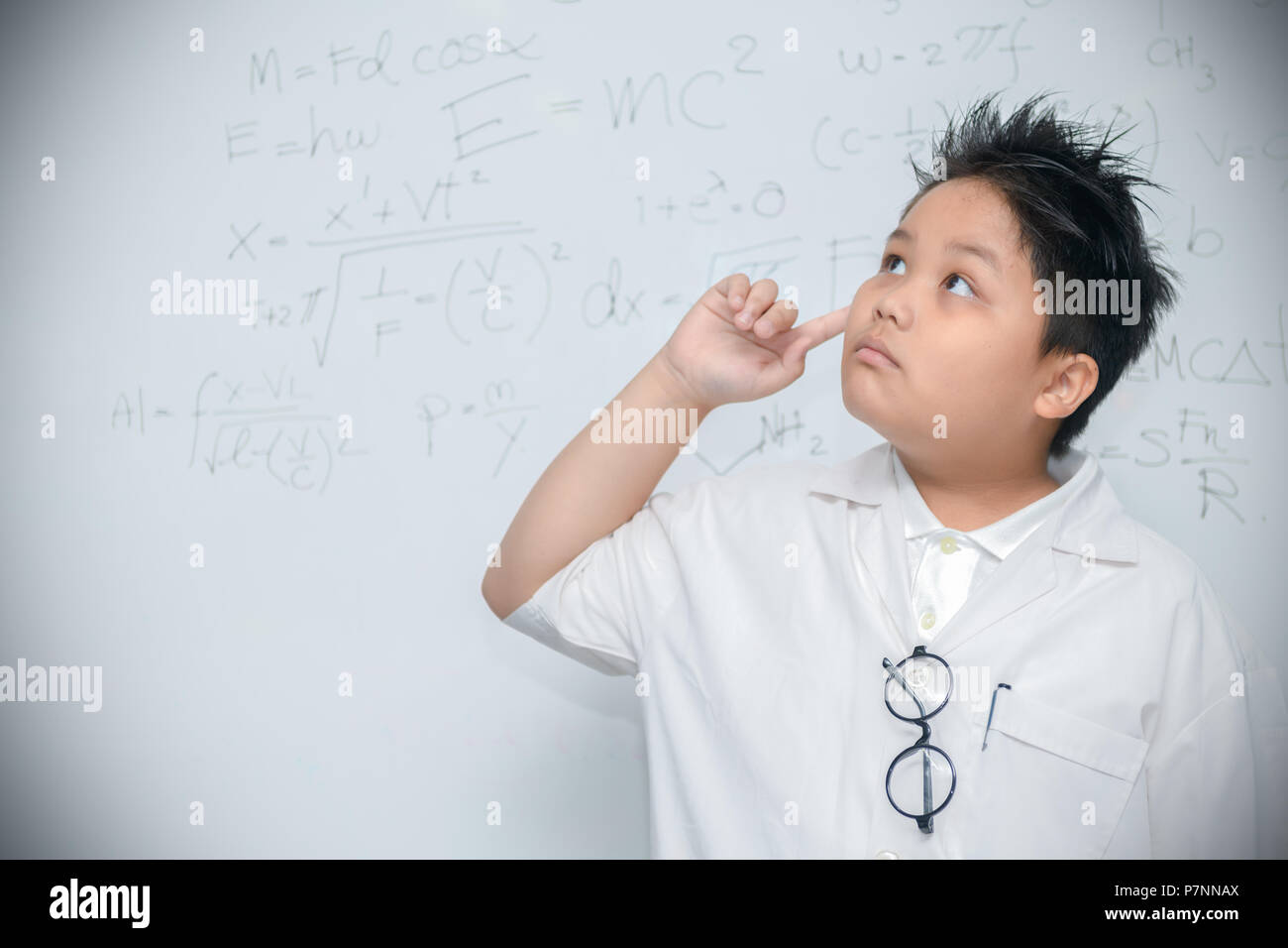 Scientist boy thinking on white borad with scientific equation, science ...