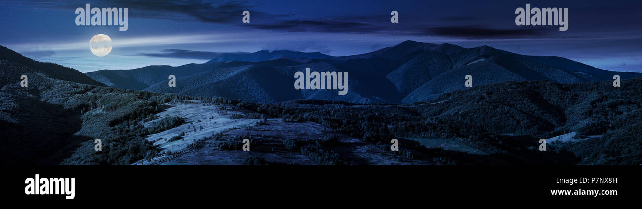 beautiful panorama of mountain ridge at night in full moon light ...