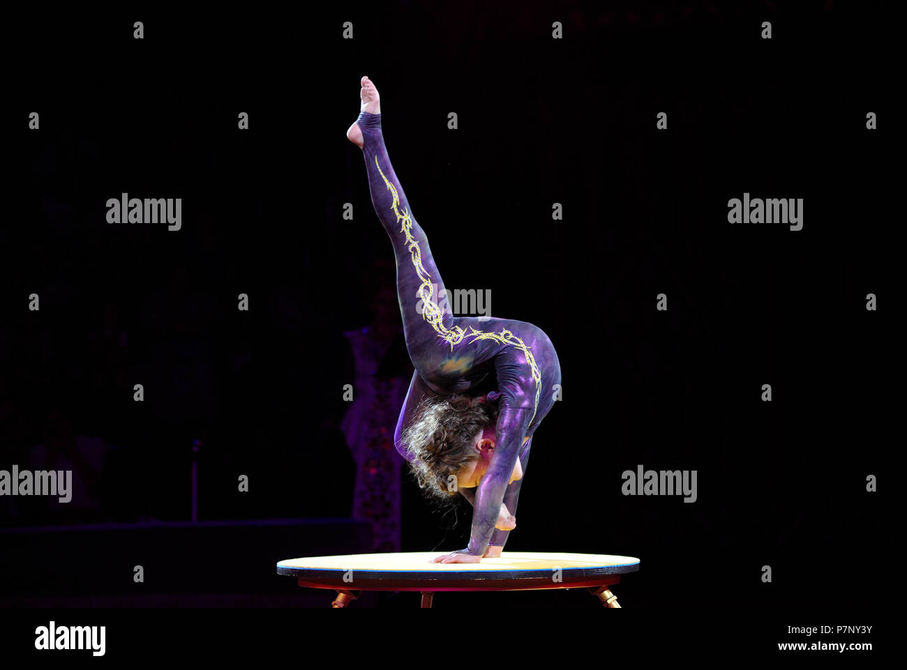 Acrobat (caoutchouc) baby girl performing on the ring of the circus ...