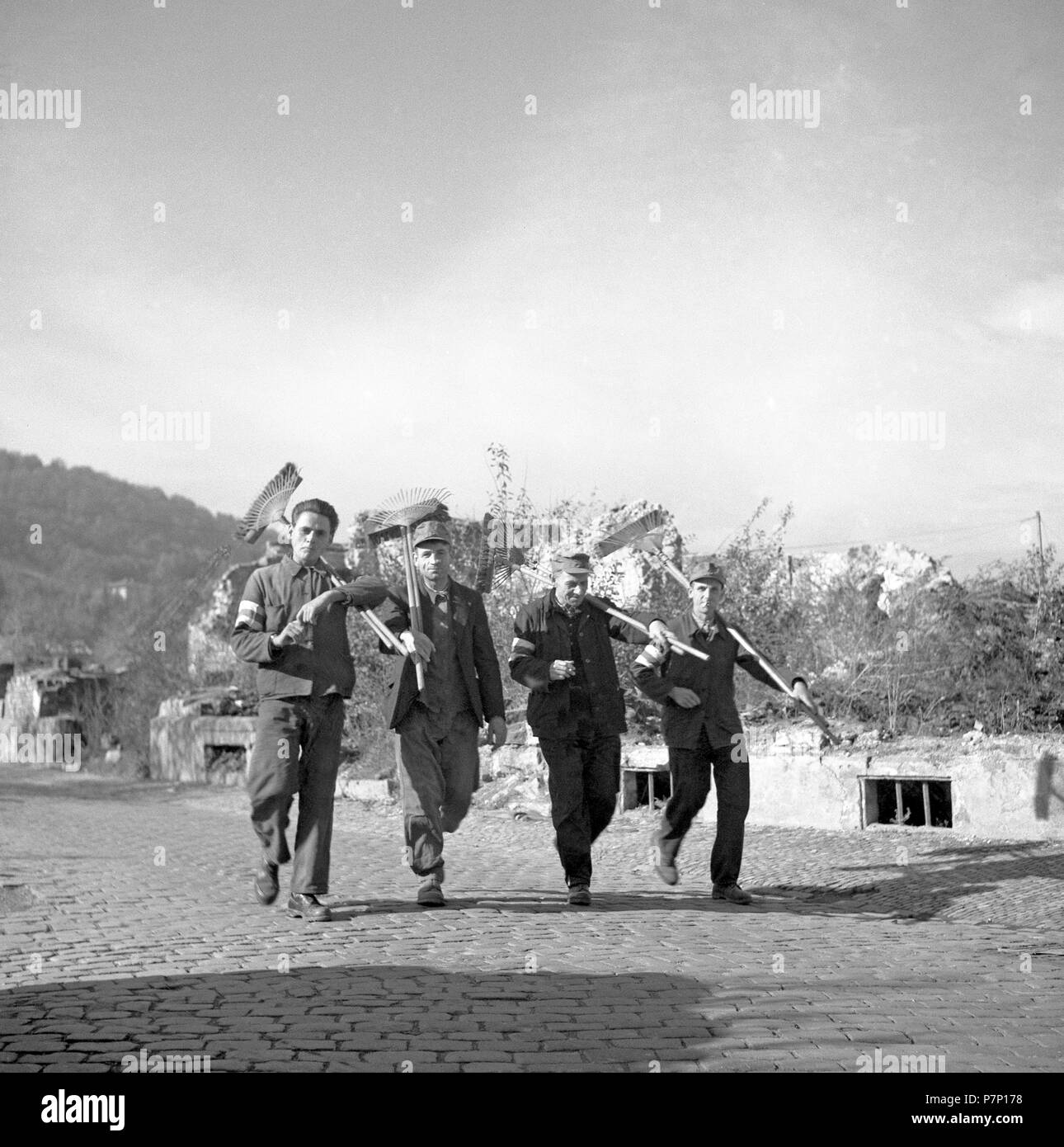 Worker with field tools on his shoulder, evening off for field workers ...