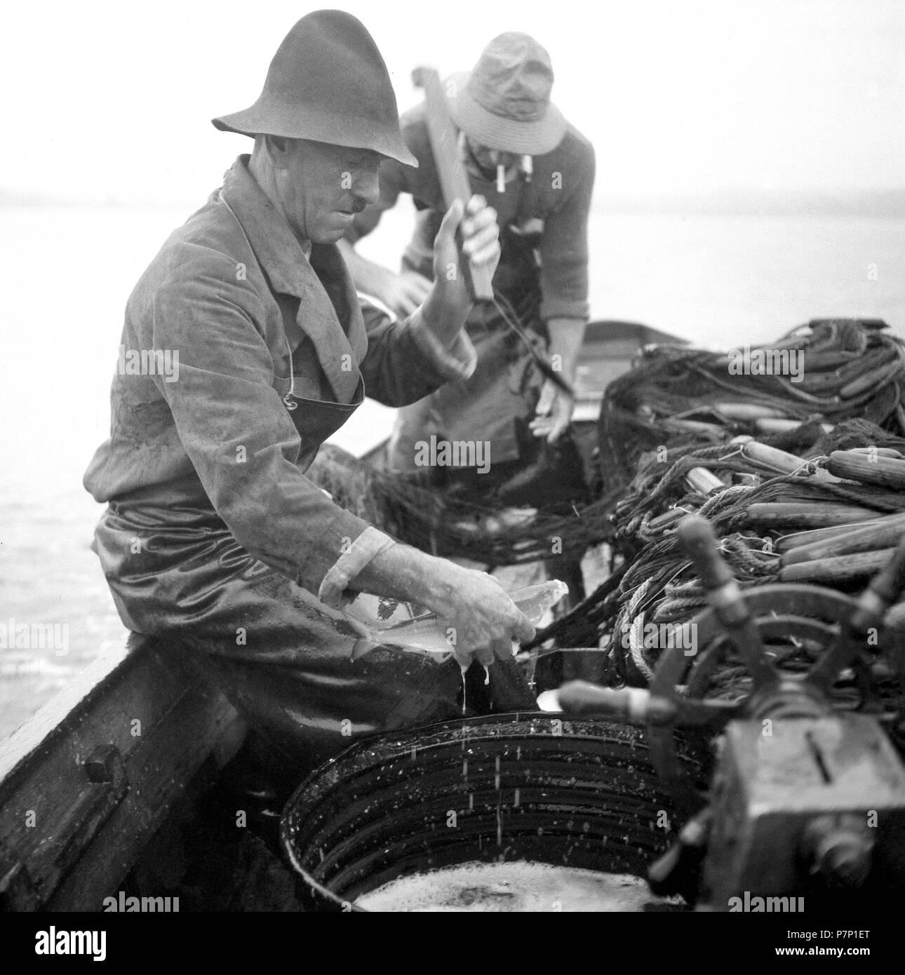 Men fishing on a fishing boat, fisherman, ca. 1955, around Freiburg ...