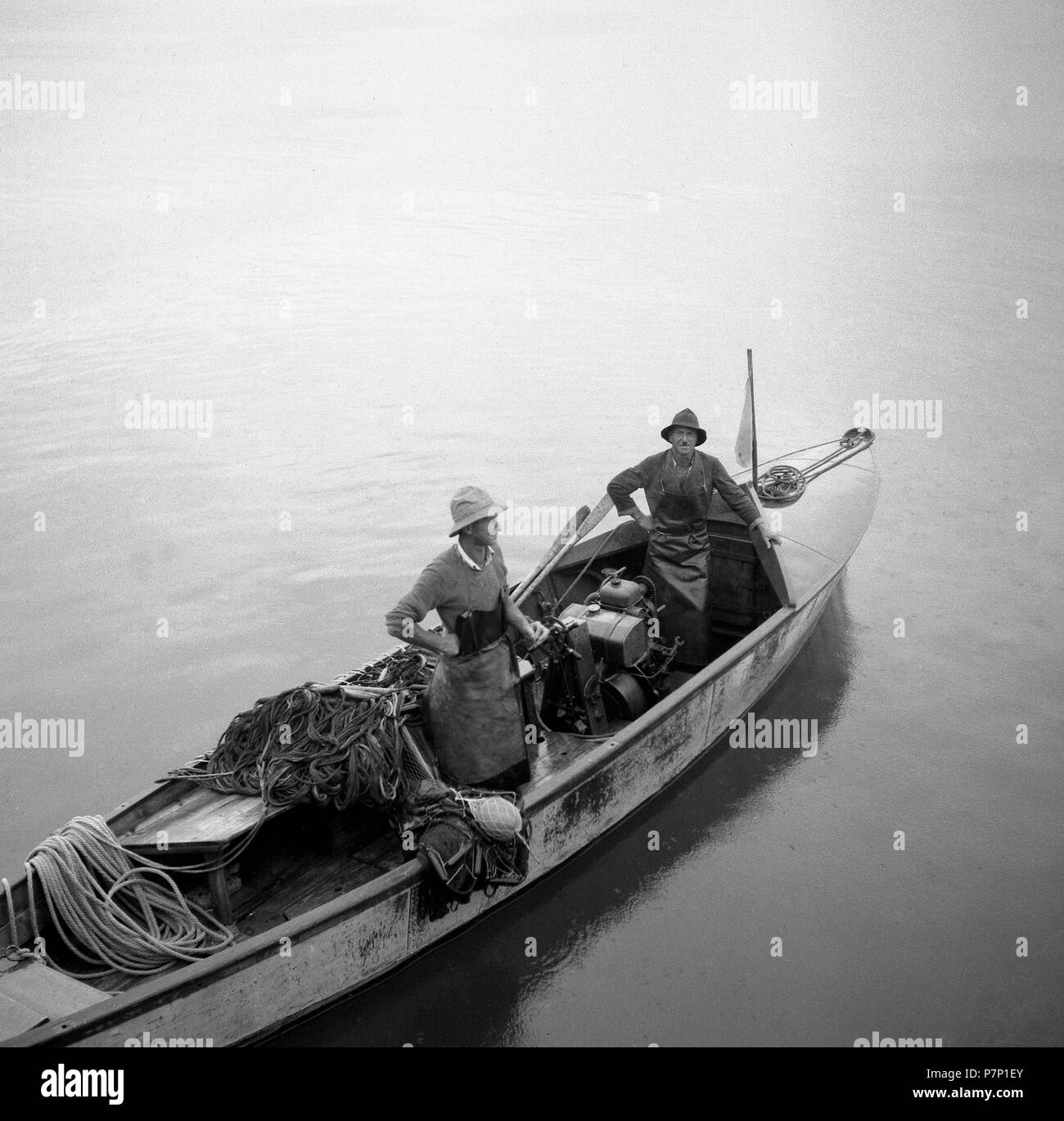 Men fishing on a fishing boat, fisherman, ca. 1955, around Freiburg ...
