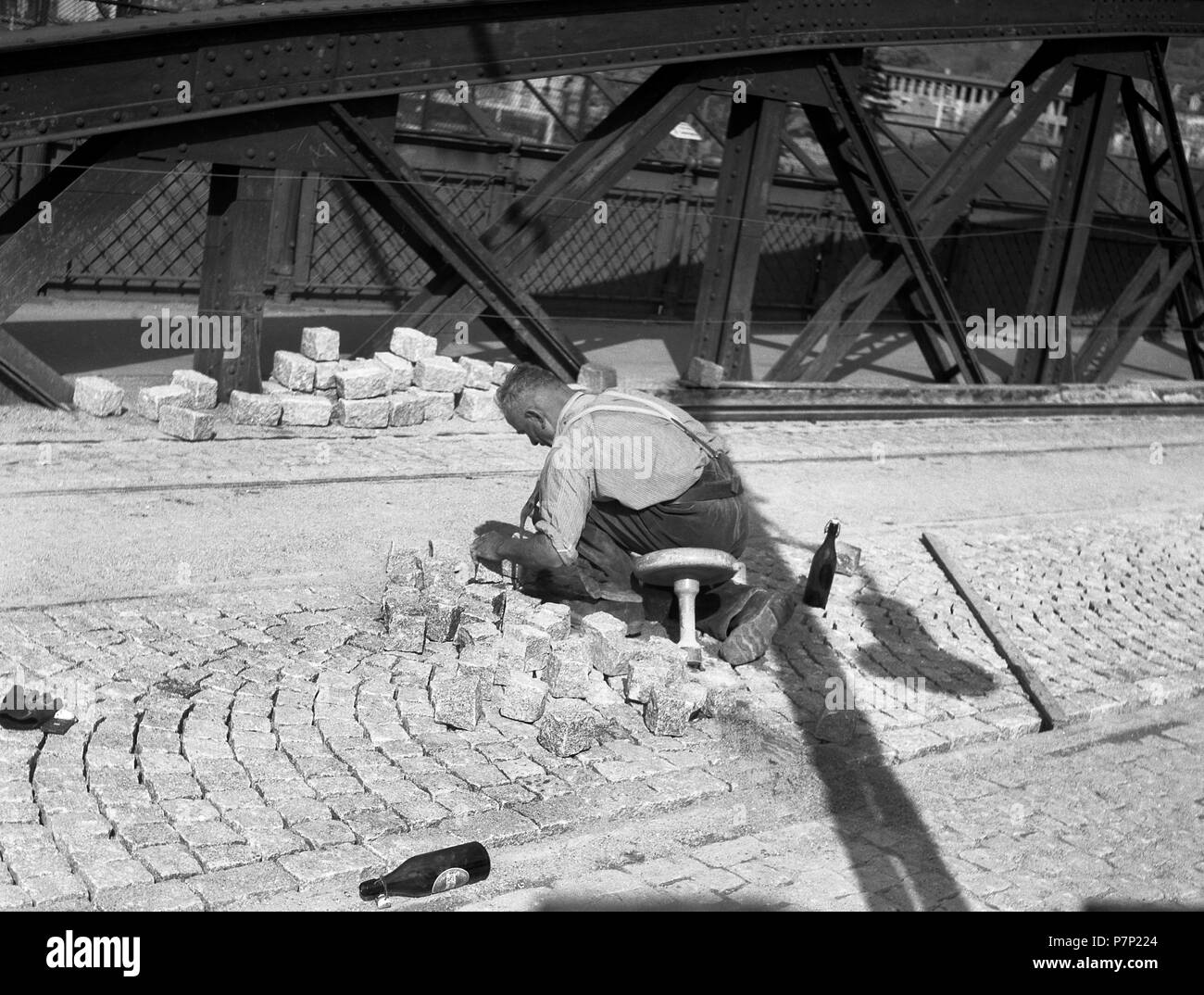 Road worker paving a road with natural stones, Freiburg ca. 1945 to ...