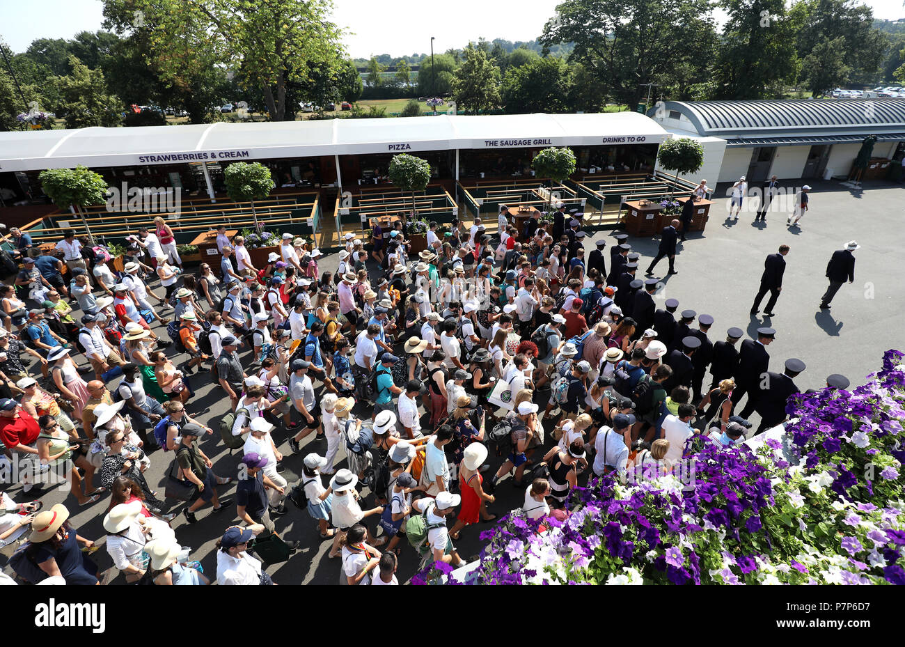 Spectators are led into the grounds on day six of the Wimbledon ...