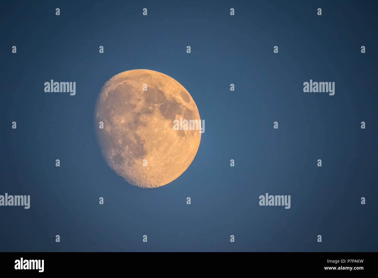 A view of full moon in blue sky background Stock Photo - Alamy
