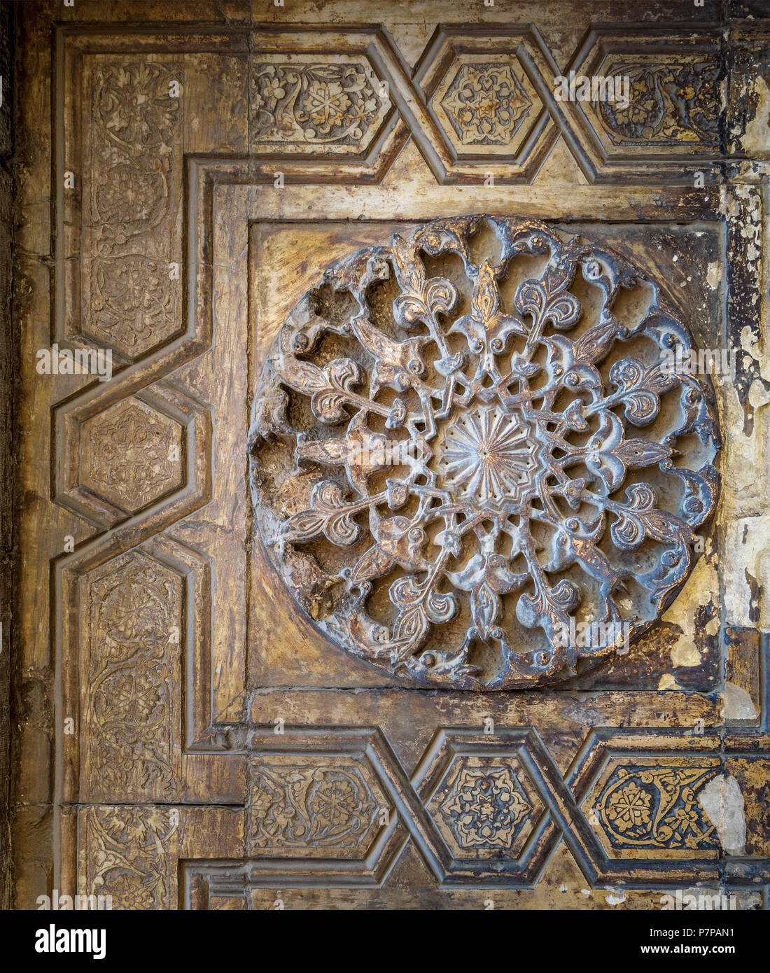 Round floral patterns framed by geometrical patterns carved into the ...
