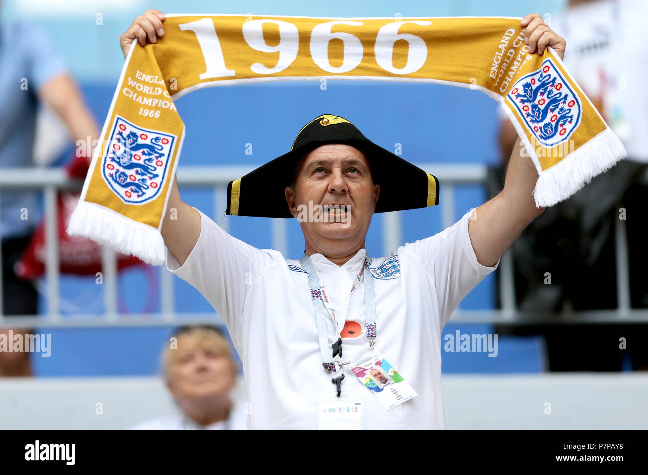 An England fan in the stands holds up a scarf celebrating England's ...