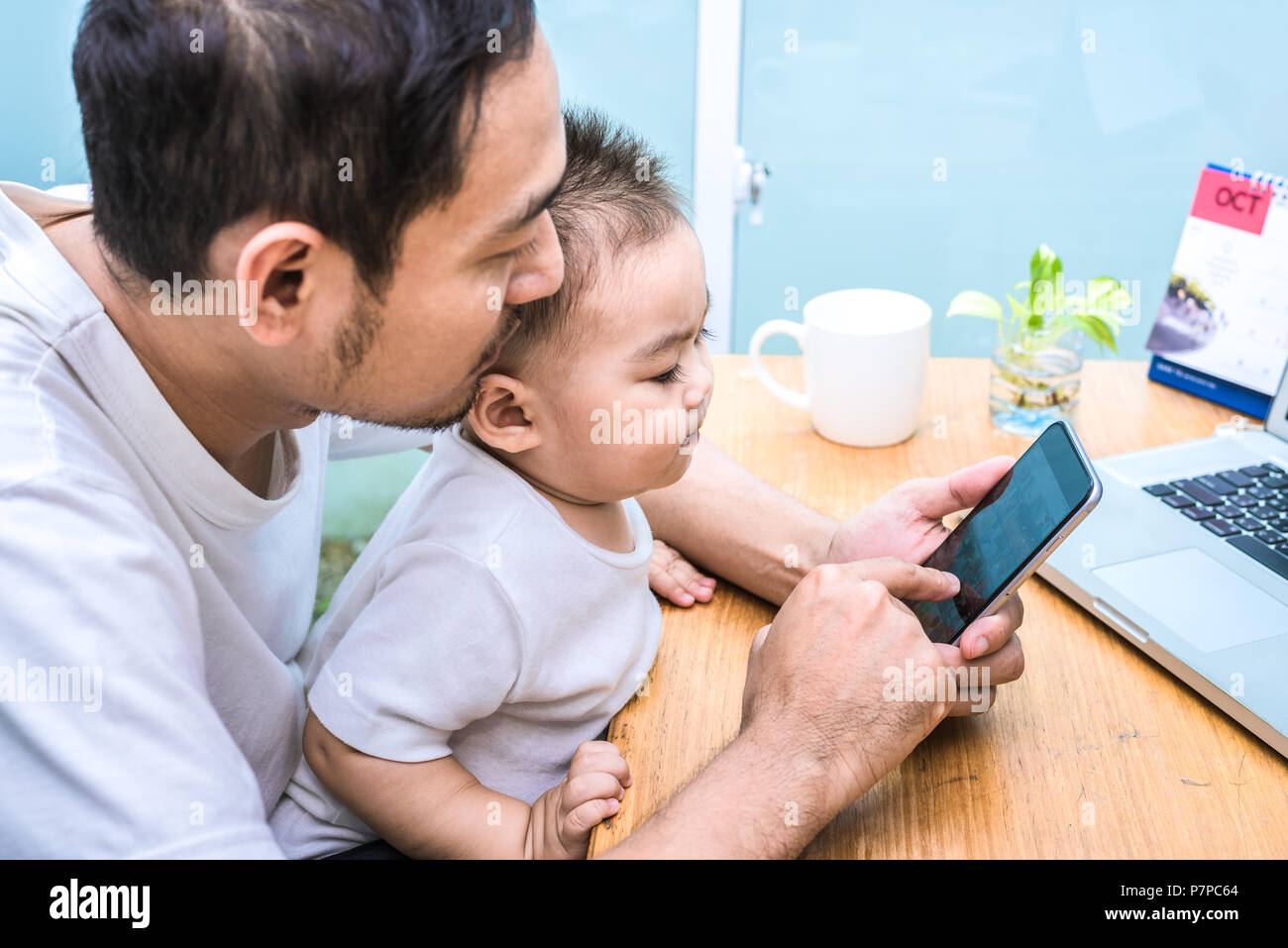 Single dad and son using laptop together happily. Technology and ...