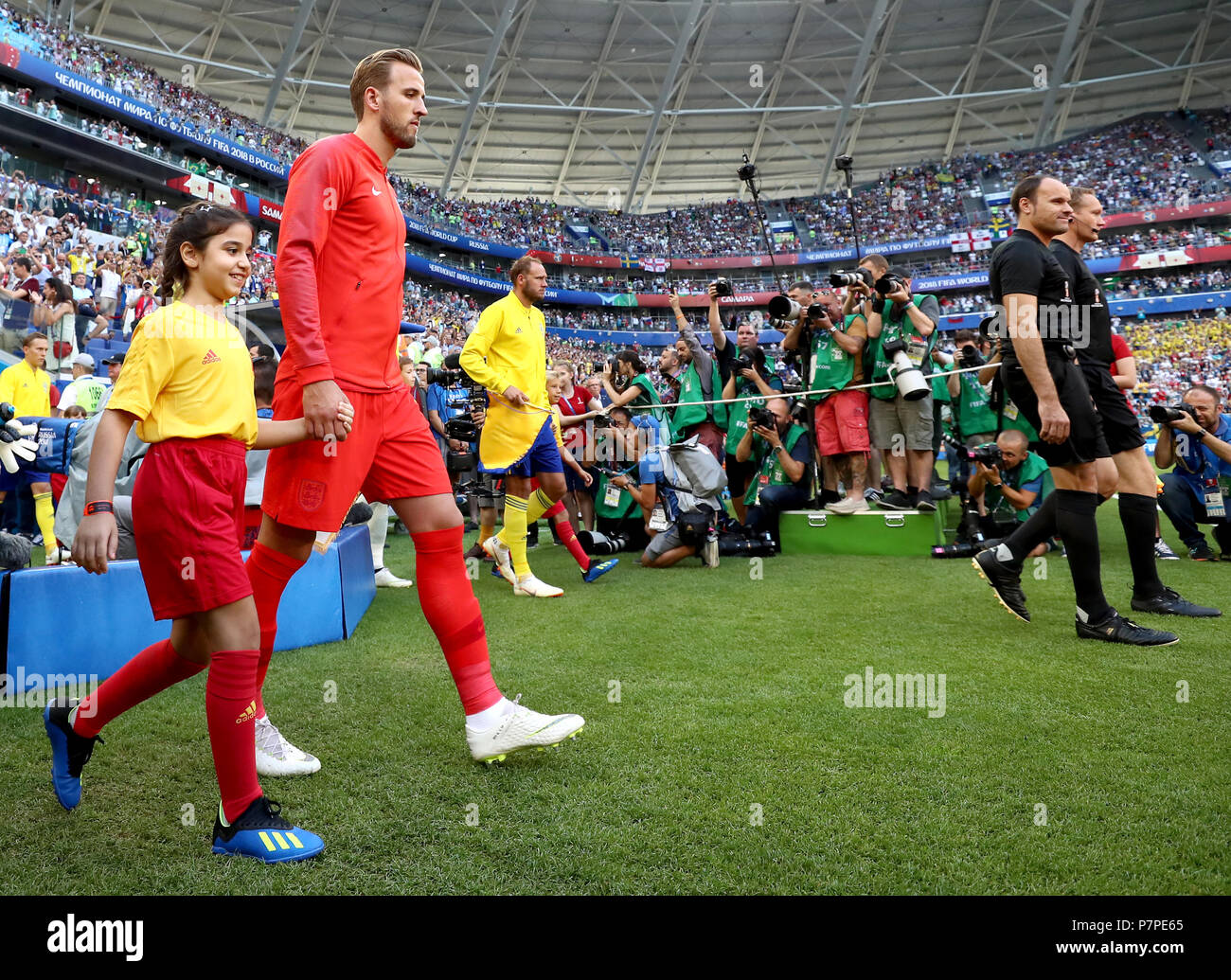 England's Harry Kane walks out with a mascot before kick-off in the ...