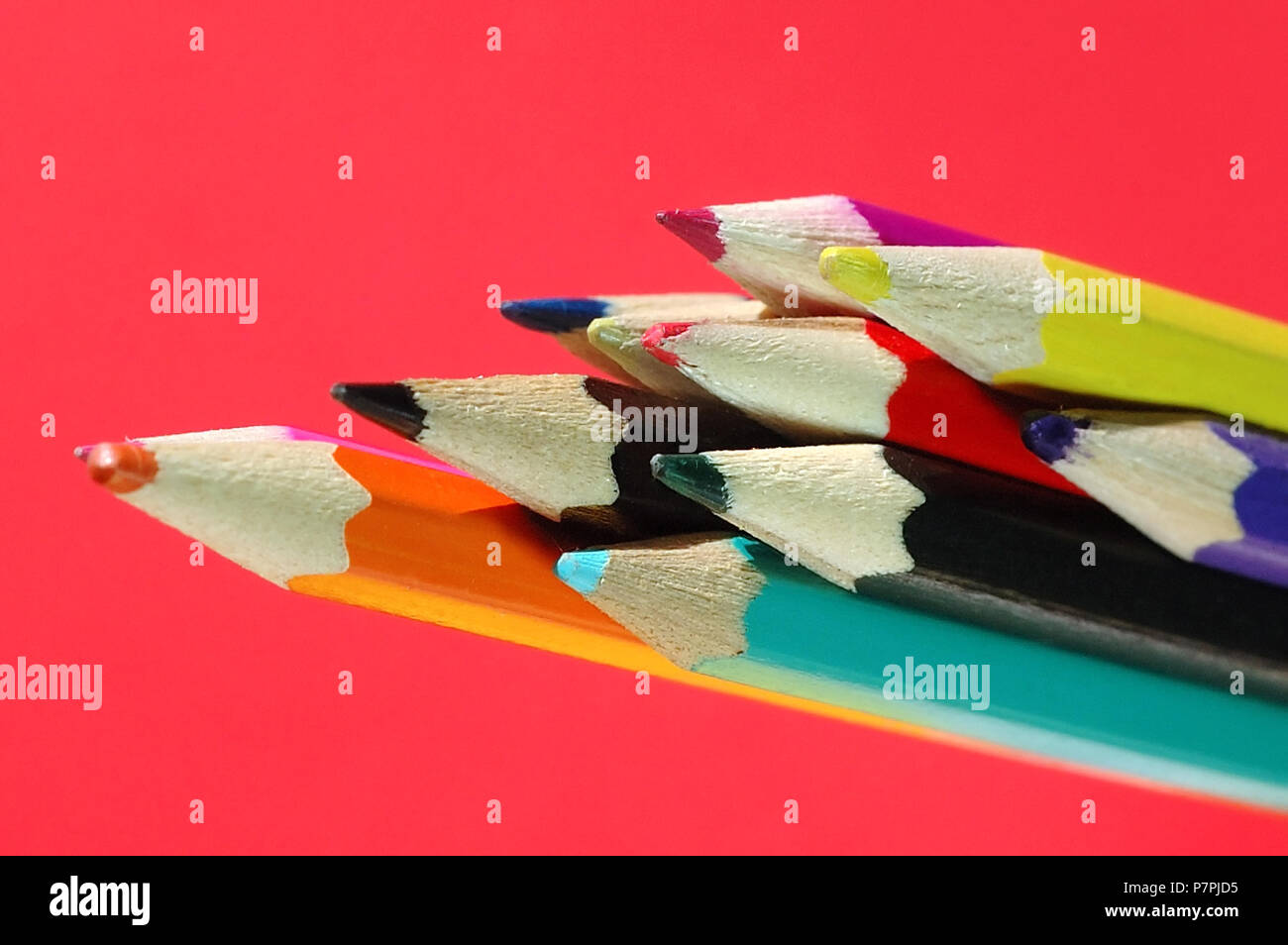 Set of colored pencils on red background Stock Photo - Alamy