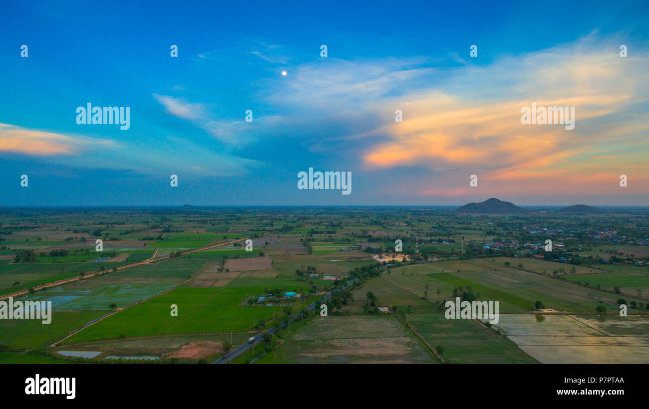 aerial view scenery sunset on new route pass in the rice field. under ...