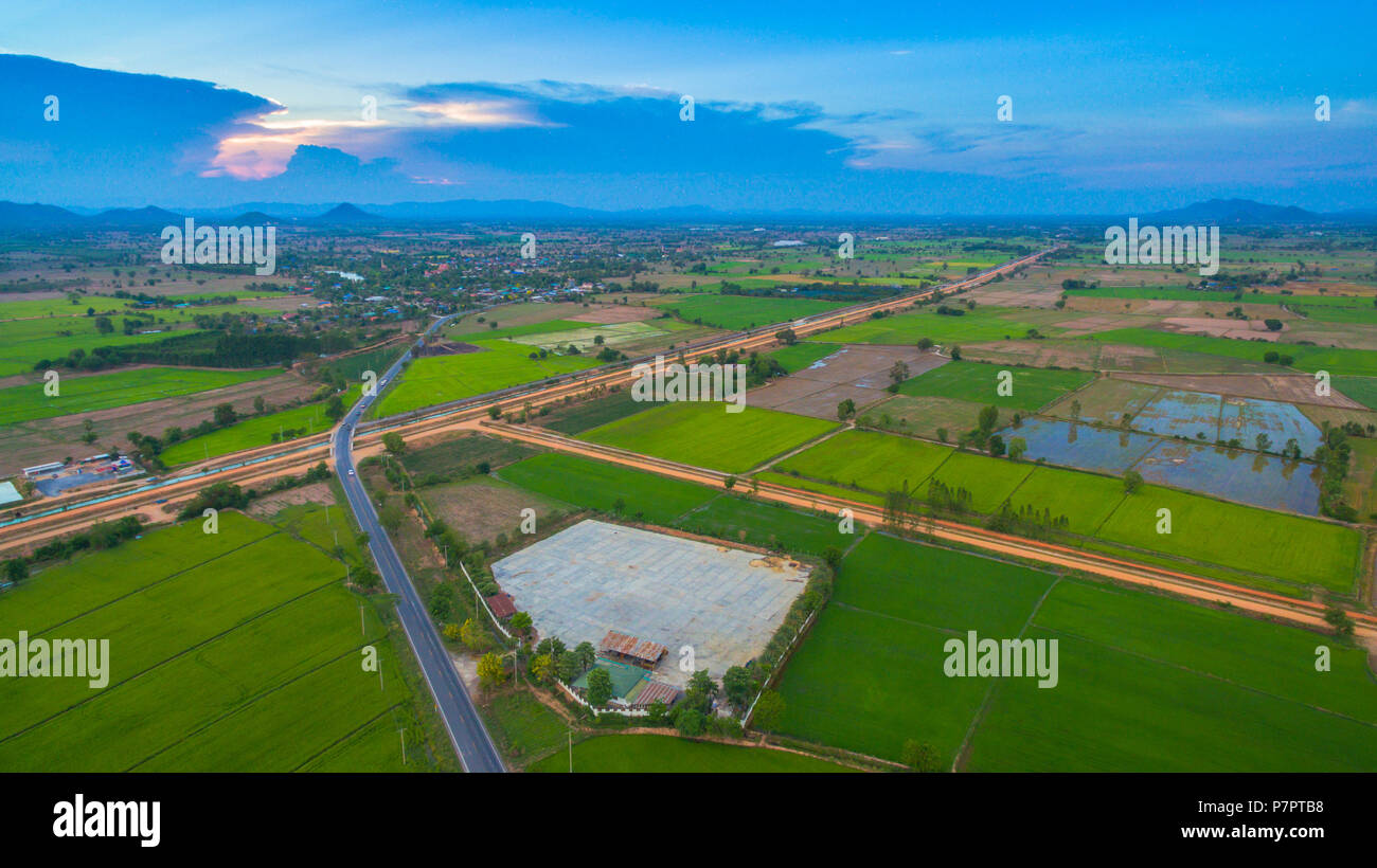 aerial view scenery sunset on new route pass in the rice field. under ...