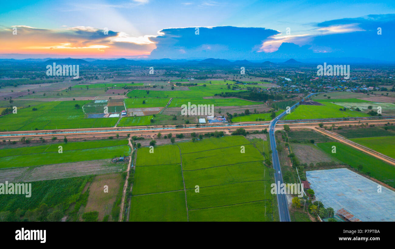 aerial view scenery sunset on new route pass in the rice field. under ...