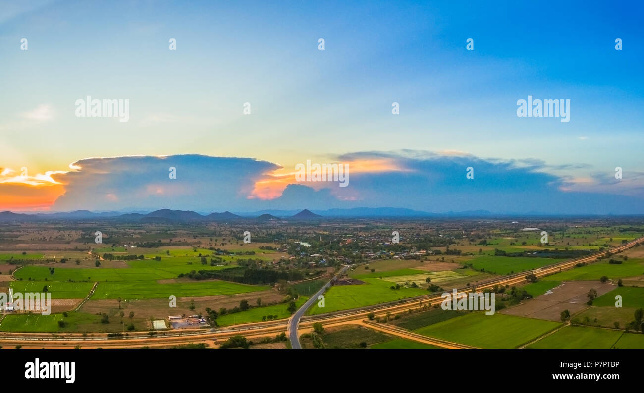 aerial view scenery sunset on new route pass in the rice field. under ...
