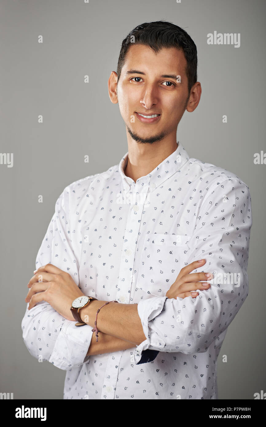 Smiling confident young man with crossed arms Stock Photo - Alamy